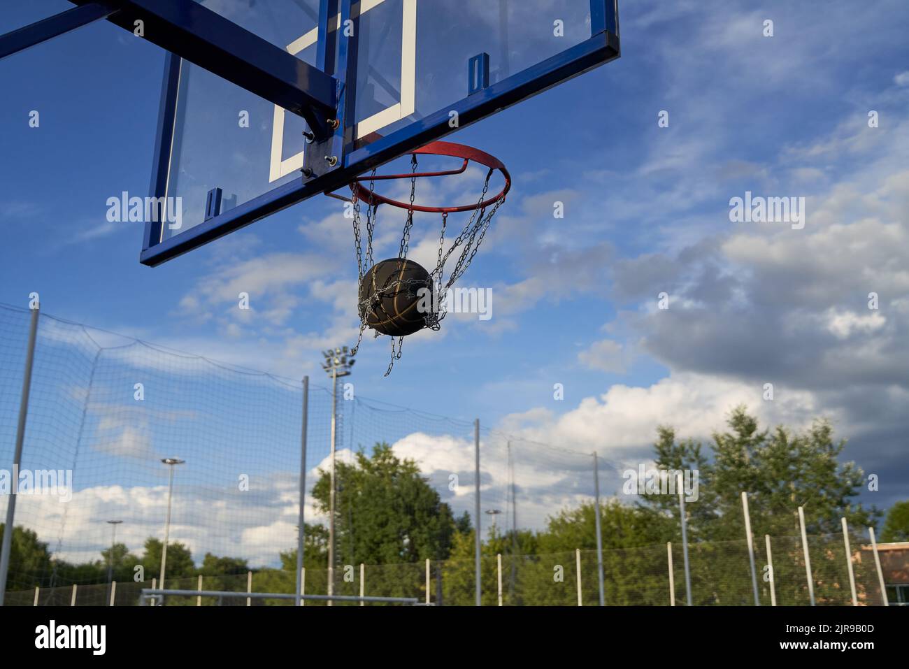 Street basketball ball falling into the hoop. Concept of success ...