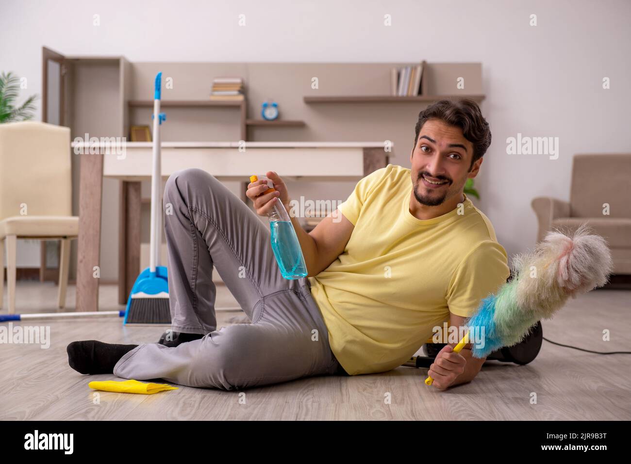 Young man cleaning the house Stock Photo - Alamy