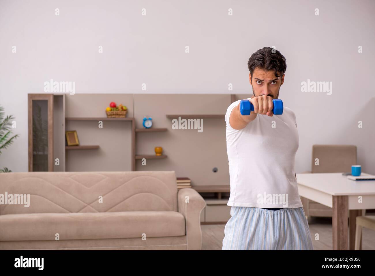 Young man doing sport exercises in the morning Stock Photo - Alamy