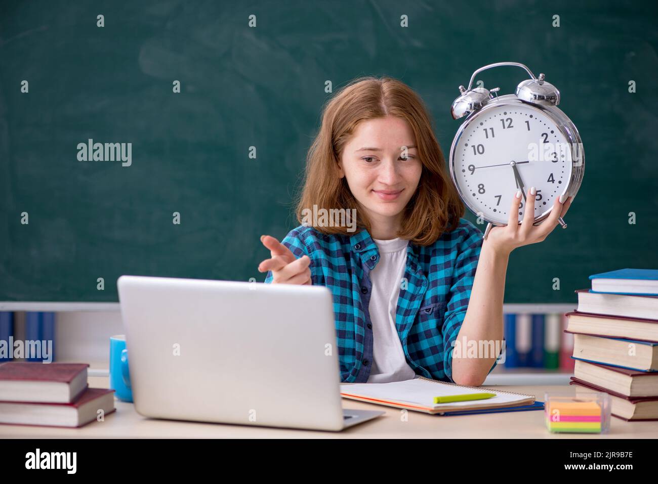 Young girl student in time management concept Stock Photo - Alamy