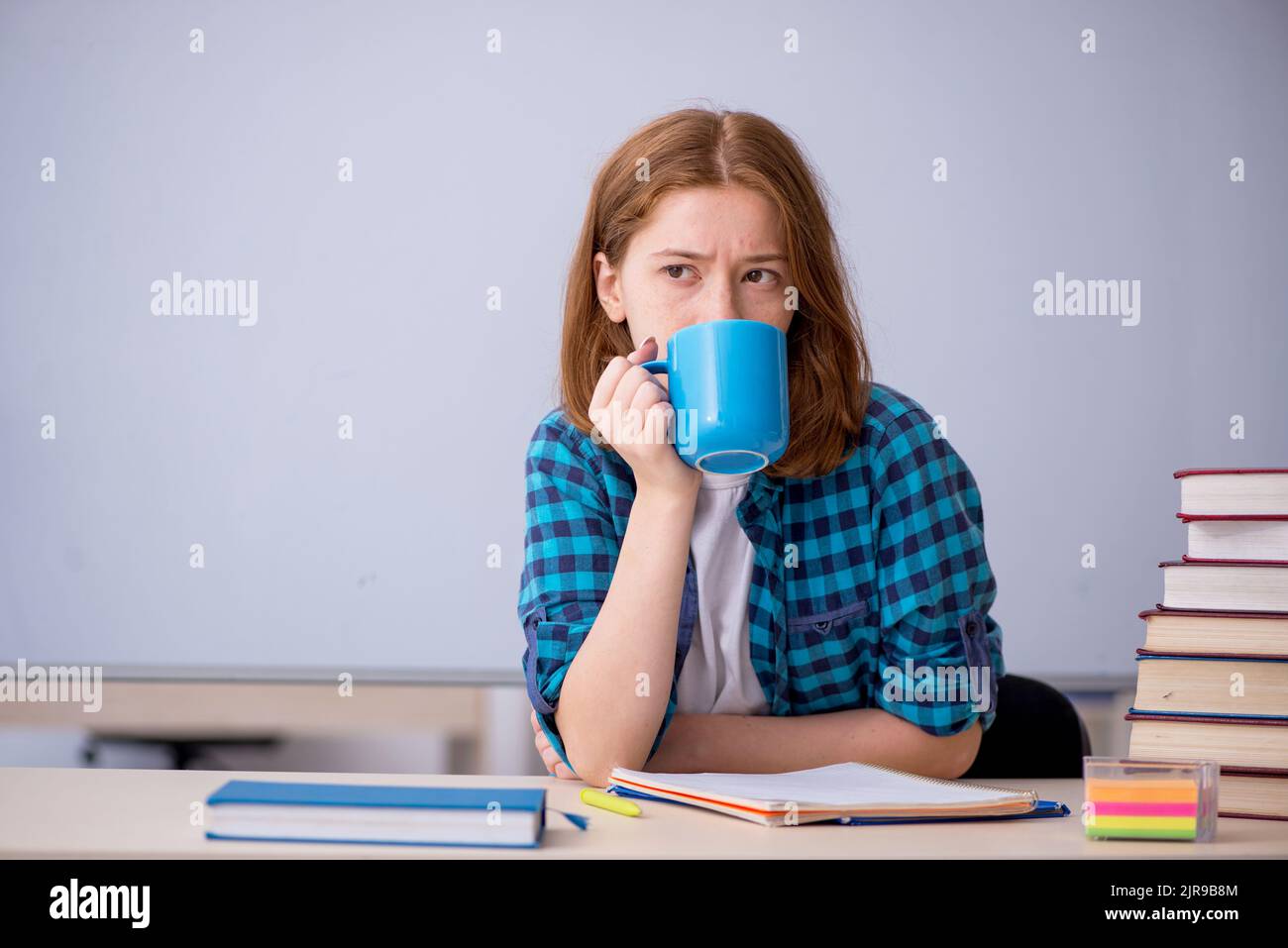 Young girl student drinking coffee during break Stock Photo - Alamy