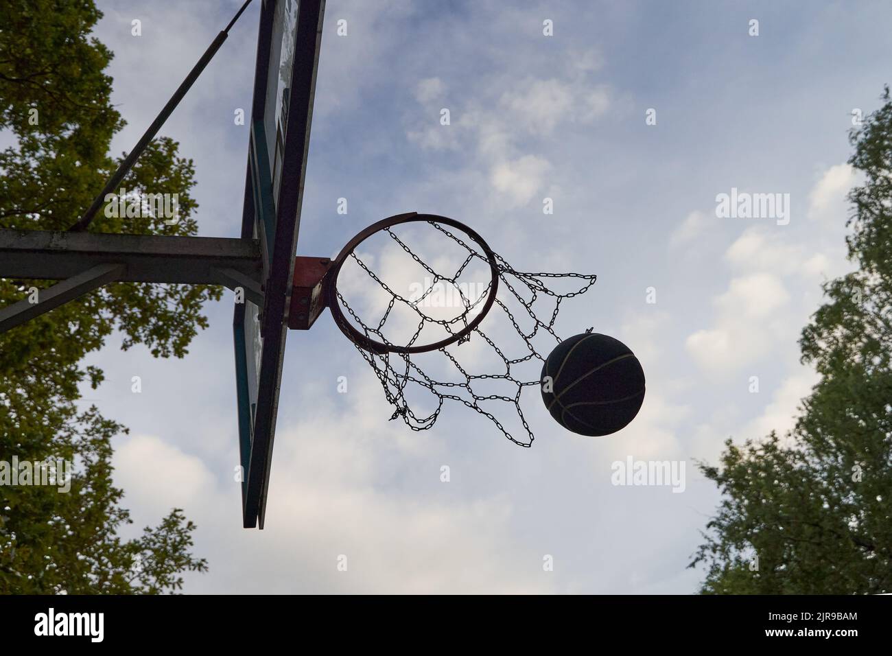 Street basketball ball falling into the hoop. Concept of success ...