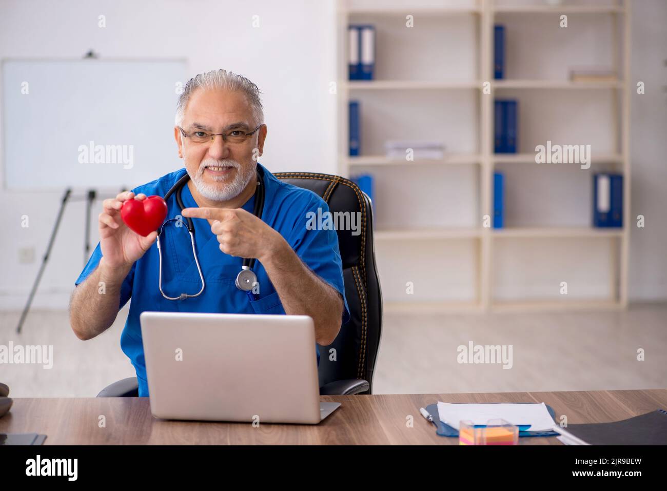 Old male doctor cardiologist working at the hospital Stock Photo - Alamy
