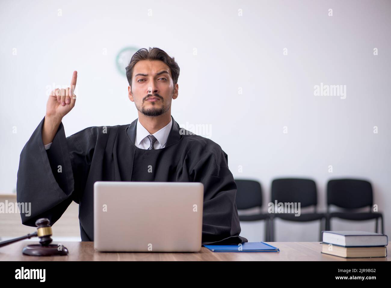 Young judge working in the courthouse Stock Photo - Alamy