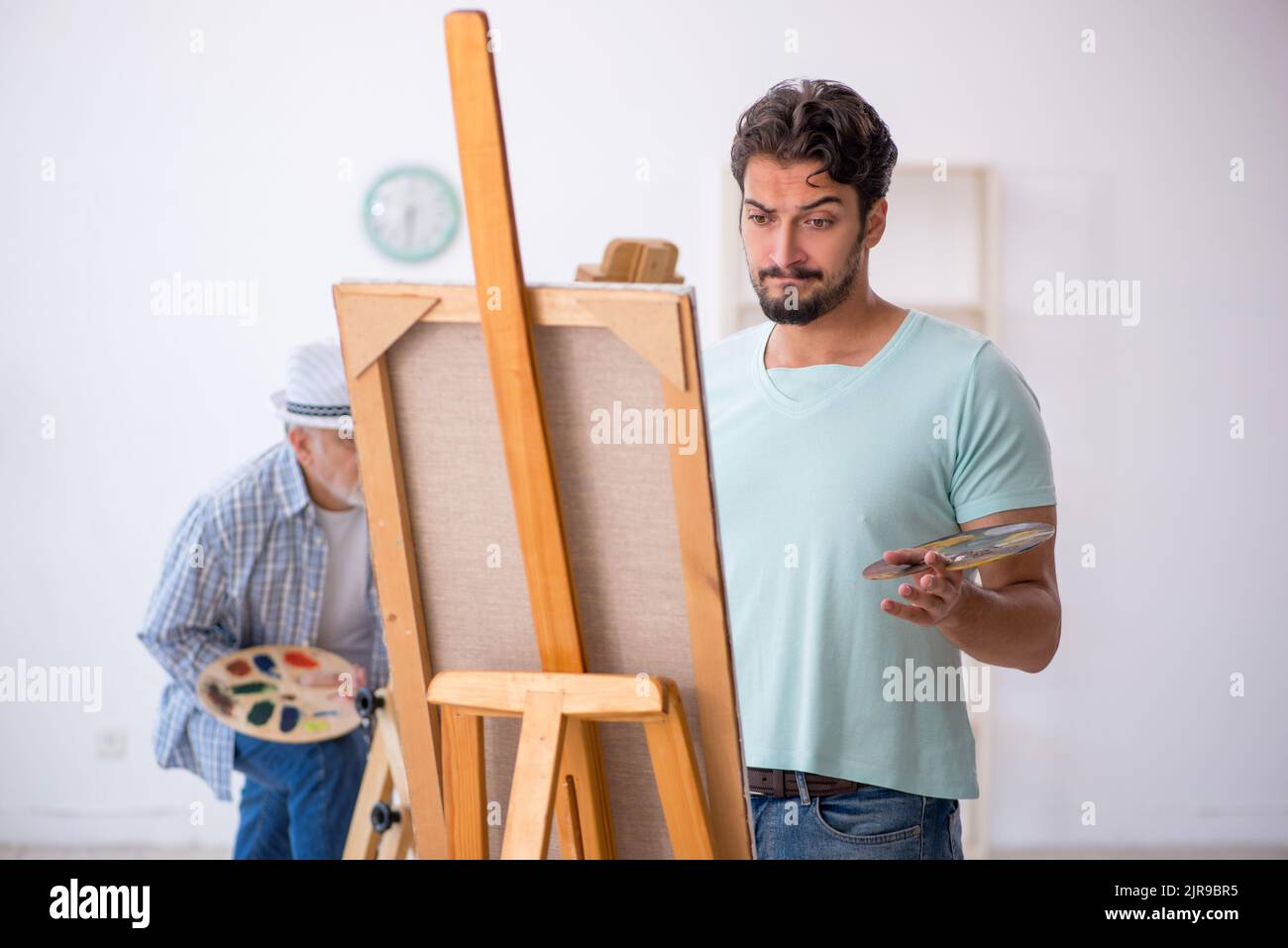 Two painters enjoying painting at home Stock Photo - Alamy