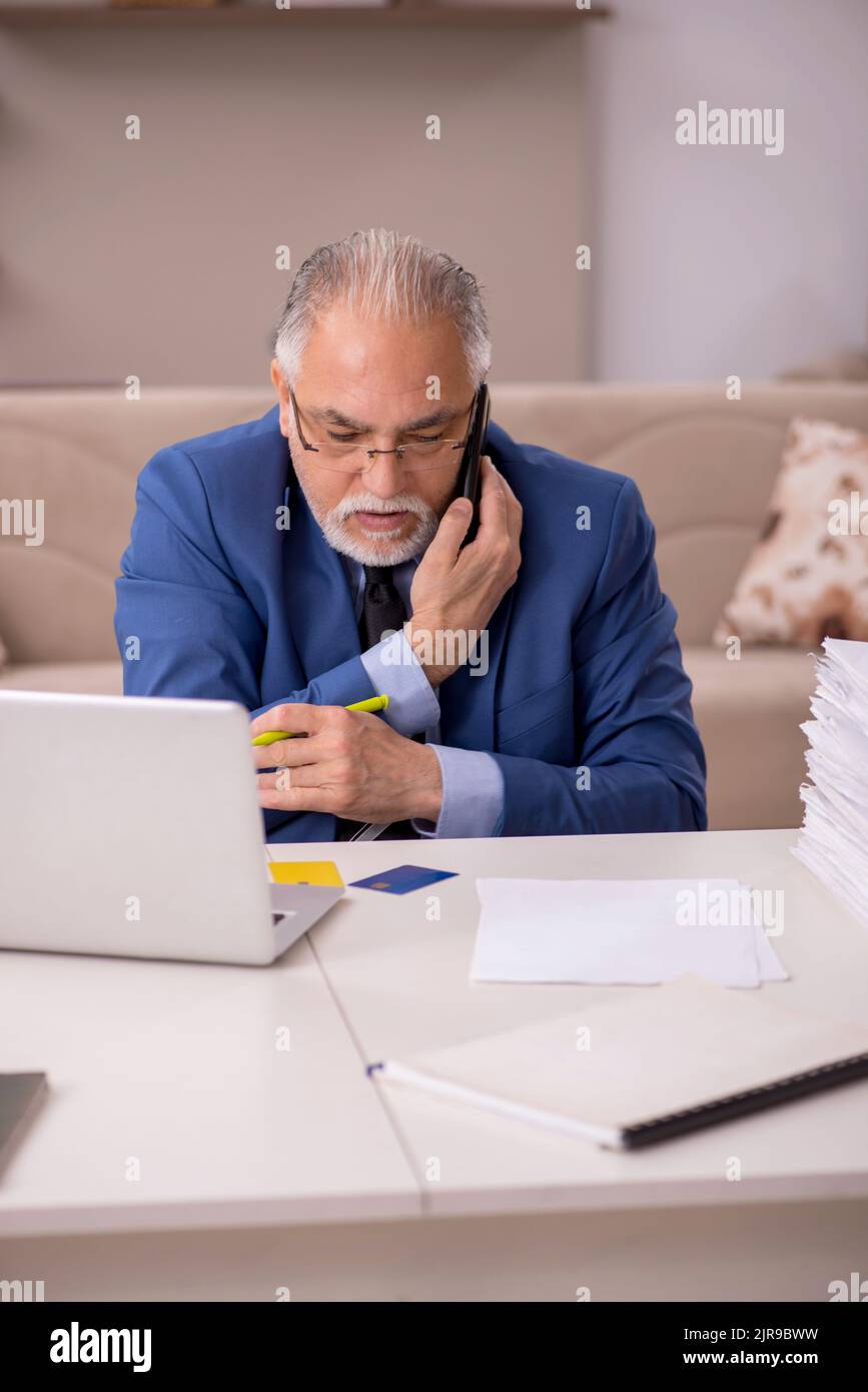 Old boss working from home during pandemic Stock Photo - Alamy