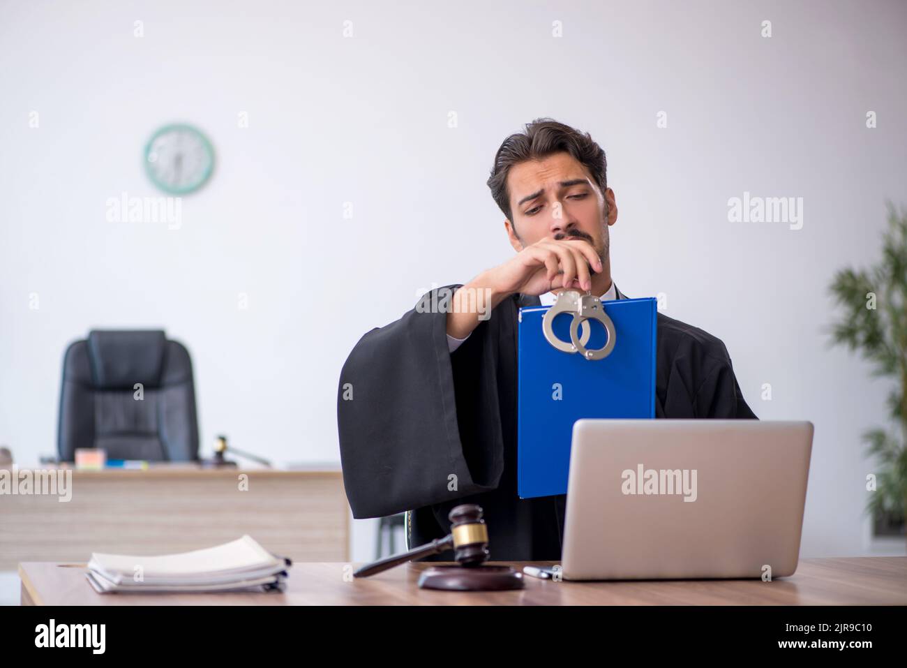 Young judge working in the courthouse Stock Photo - Alamy