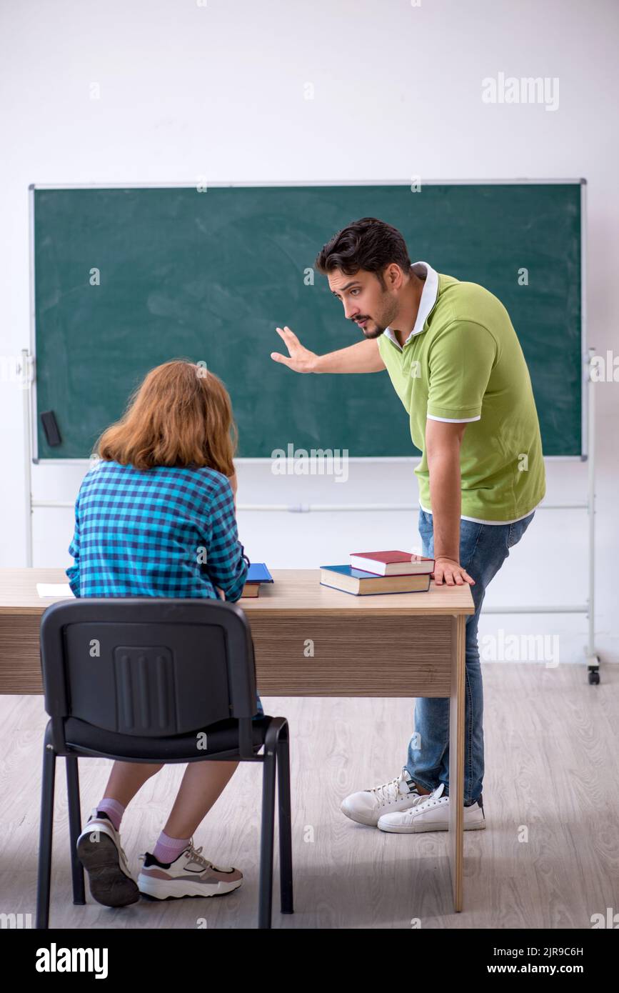 Young teacher teaching student in the classroom Stock Photo - Alamy