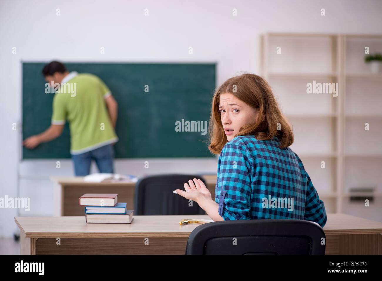 Young teacher teaching student in the classroom Stock Photo - Alamy