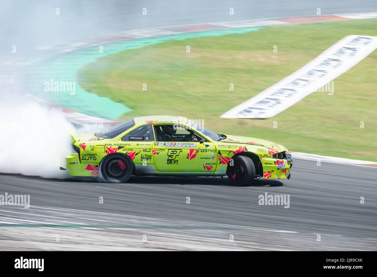 A yellow Nissan Silvia S14 Zenki skidding on a race track Stock Photo ...