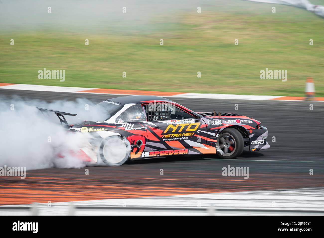A tuned Nissan Silvia S14 Zenki skidding on a race track Stock Photo ...