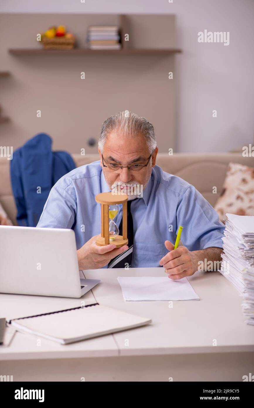 Old boss working from home during pandemic Stock Photo - Alamy