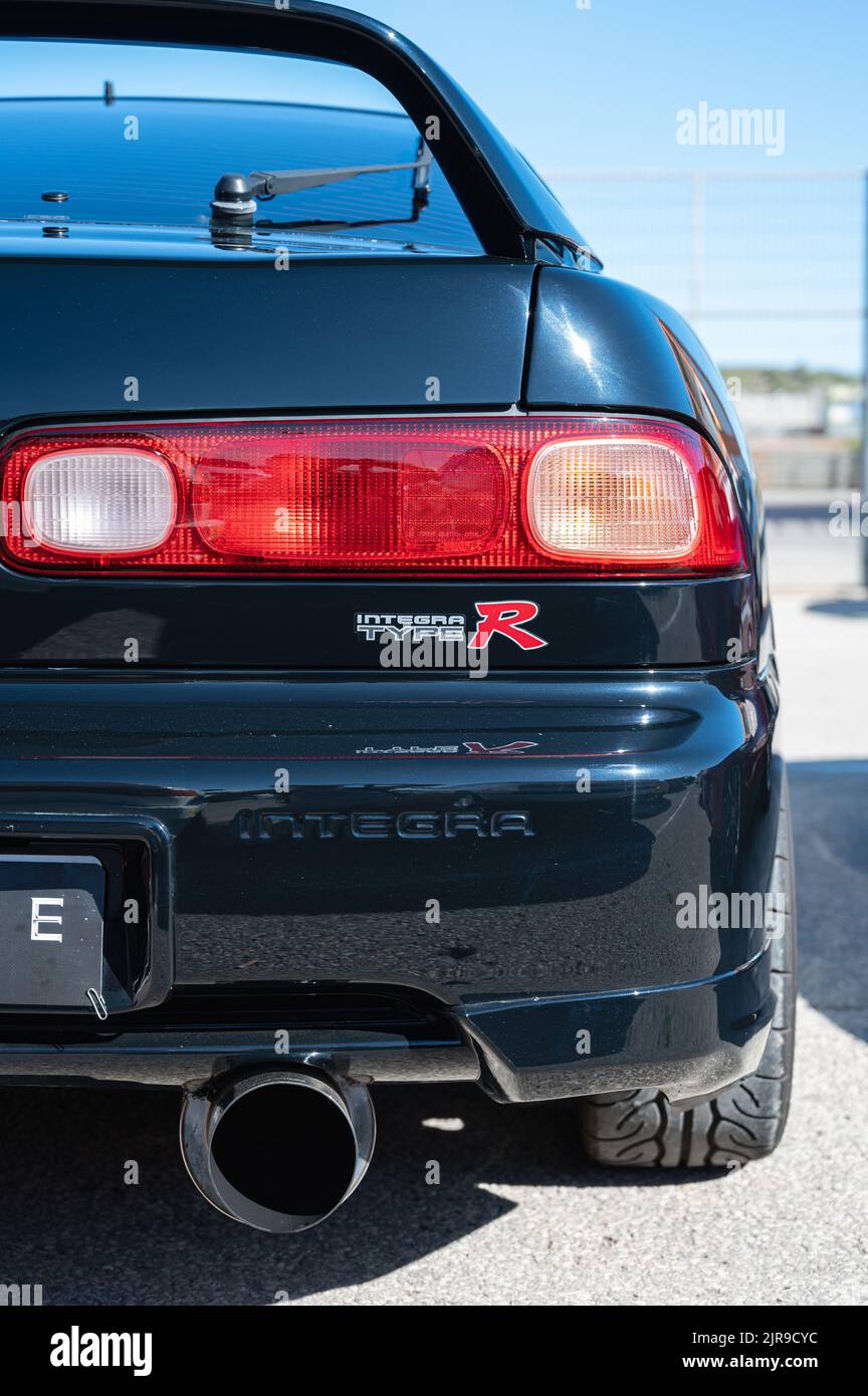 A vertical closeup of a rear of a black third-generation Honda Integra ...