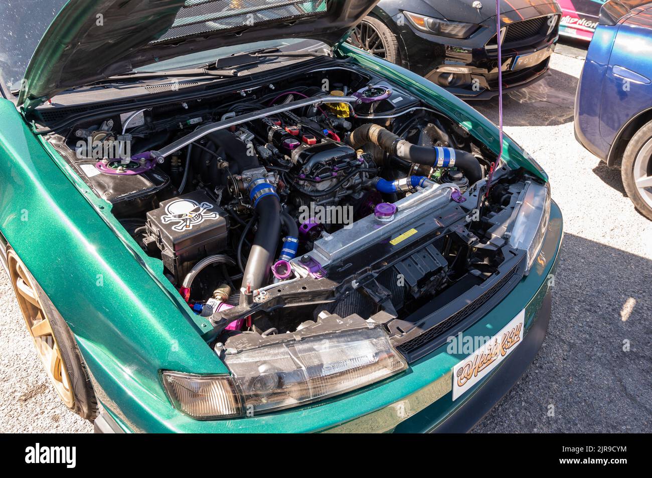 A detail of an improved gasoline engine of green Nissan Silvia S14 with ...
