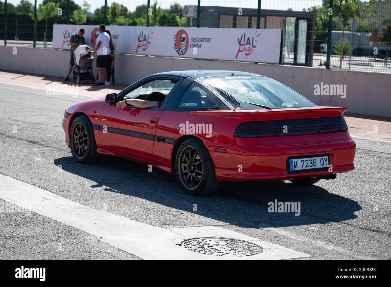 A rear view of a red vintage first-generation Mitsubishi Eclipse sports ...