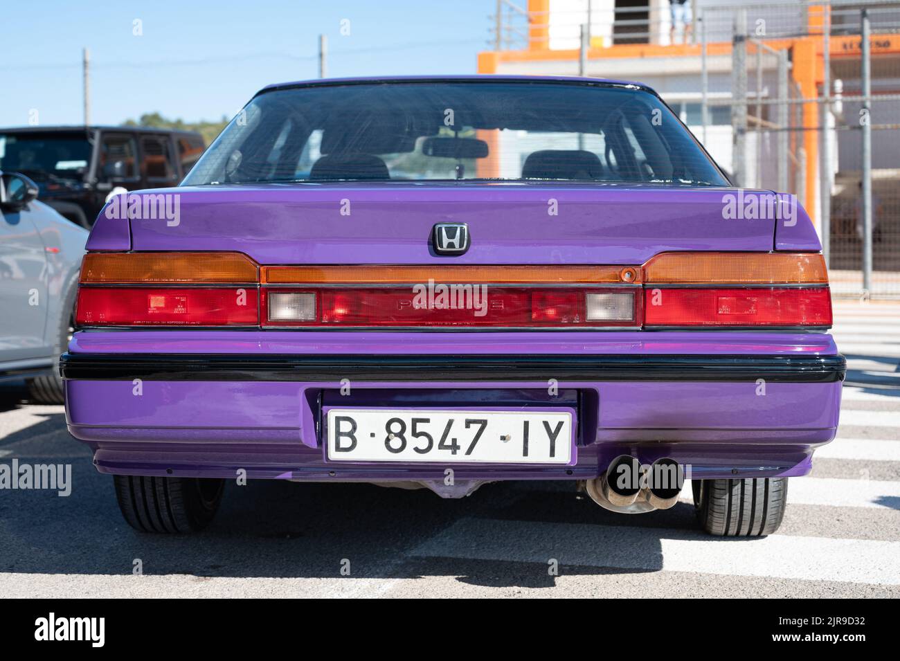 A rear view of a purple classic Japanese third-generation Honda Prelude ...
