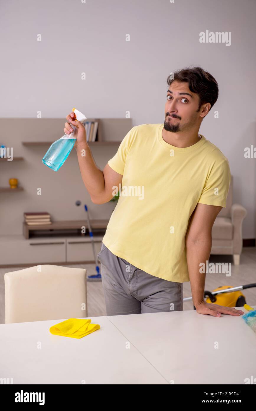 Young man cleaning the house Stock Photo - Alamy