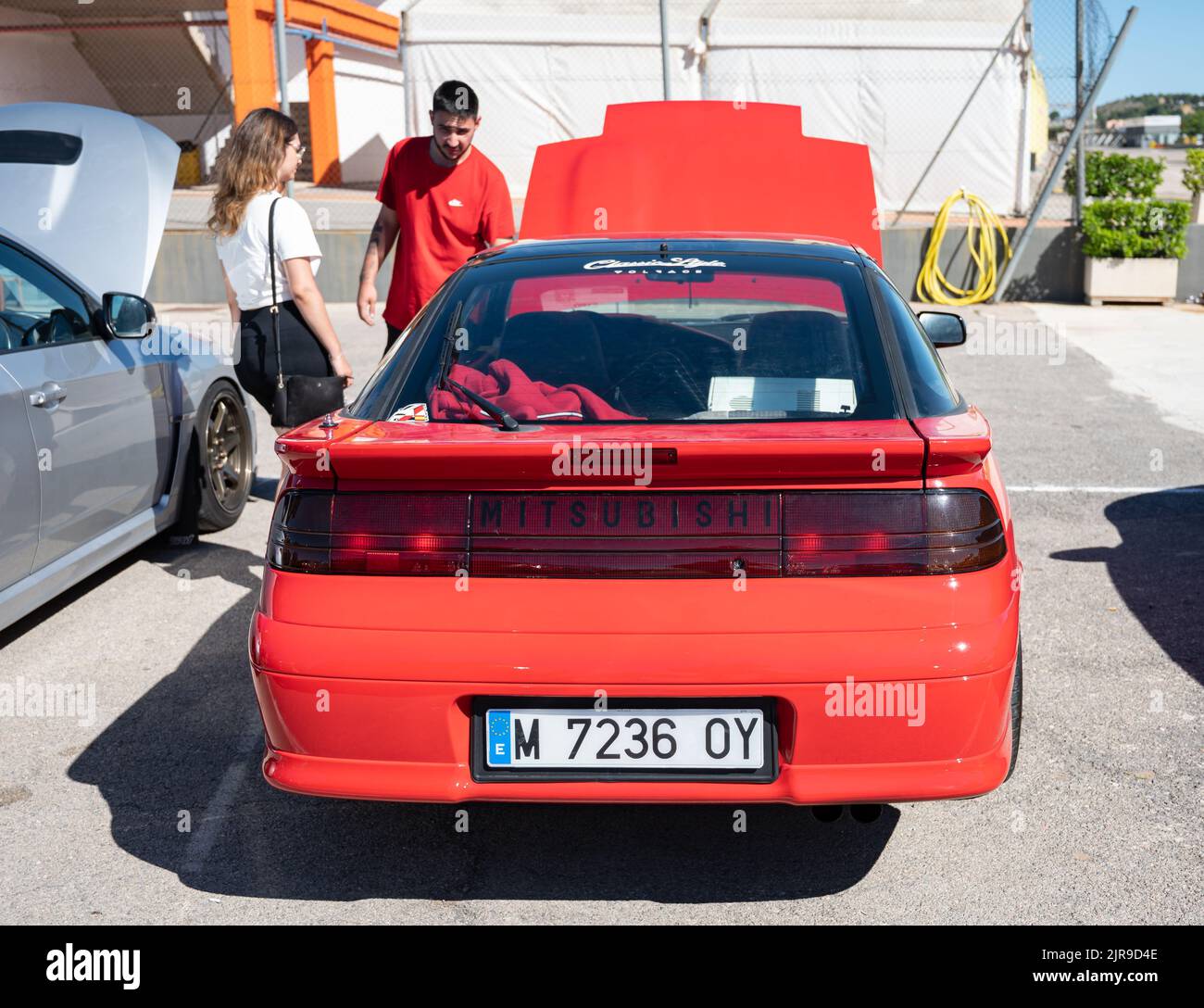 A rear view of a red vintage first-generation Mitsubishi Eclipse sports ...