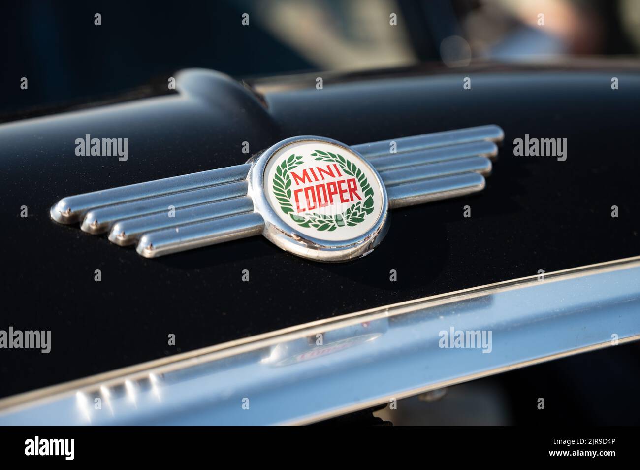 A closeup of an emblem detail of a vintage black Mini Cooper Stock ...