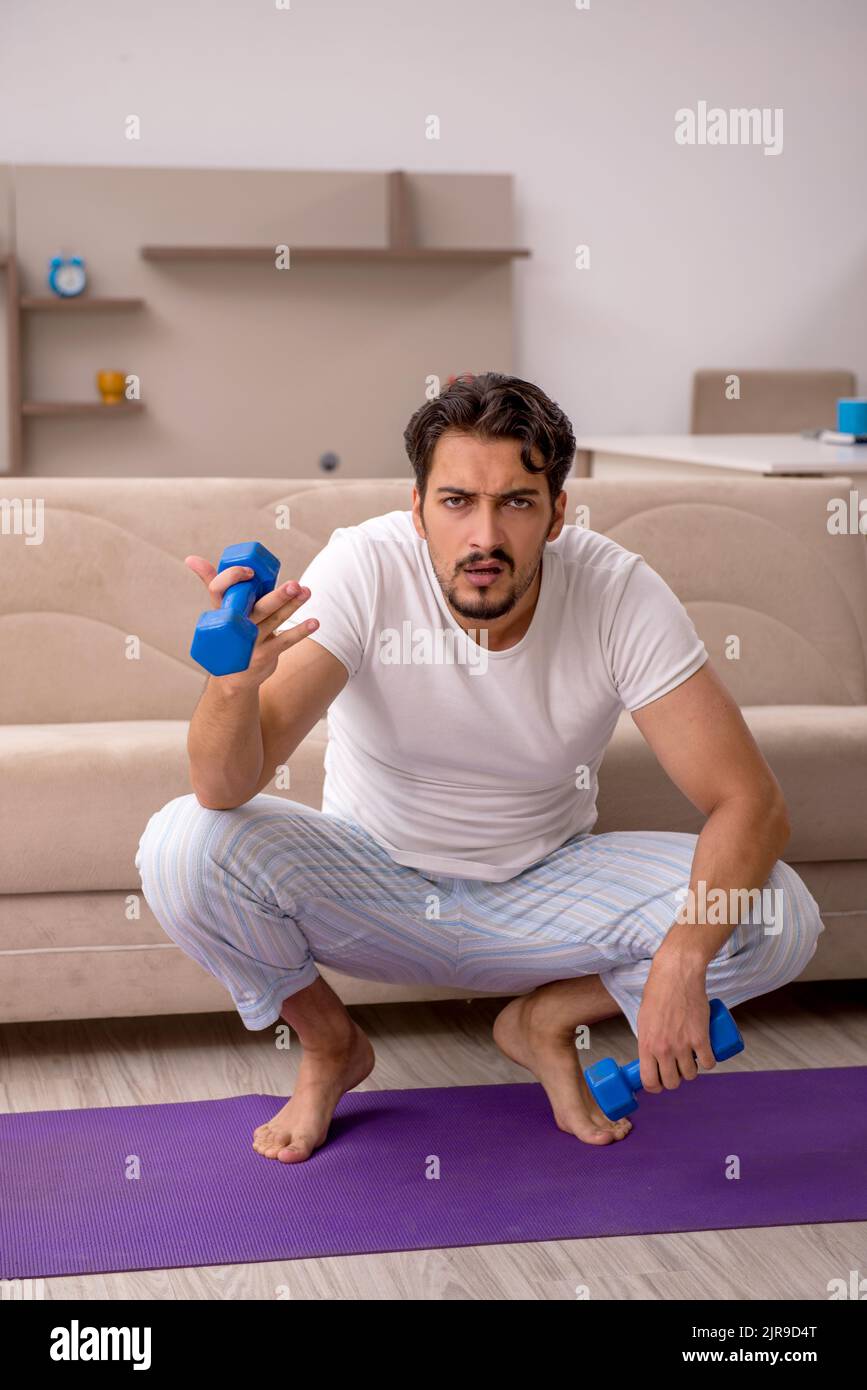 Young man doing sport exercises in the morning Stock Photo - Alamy