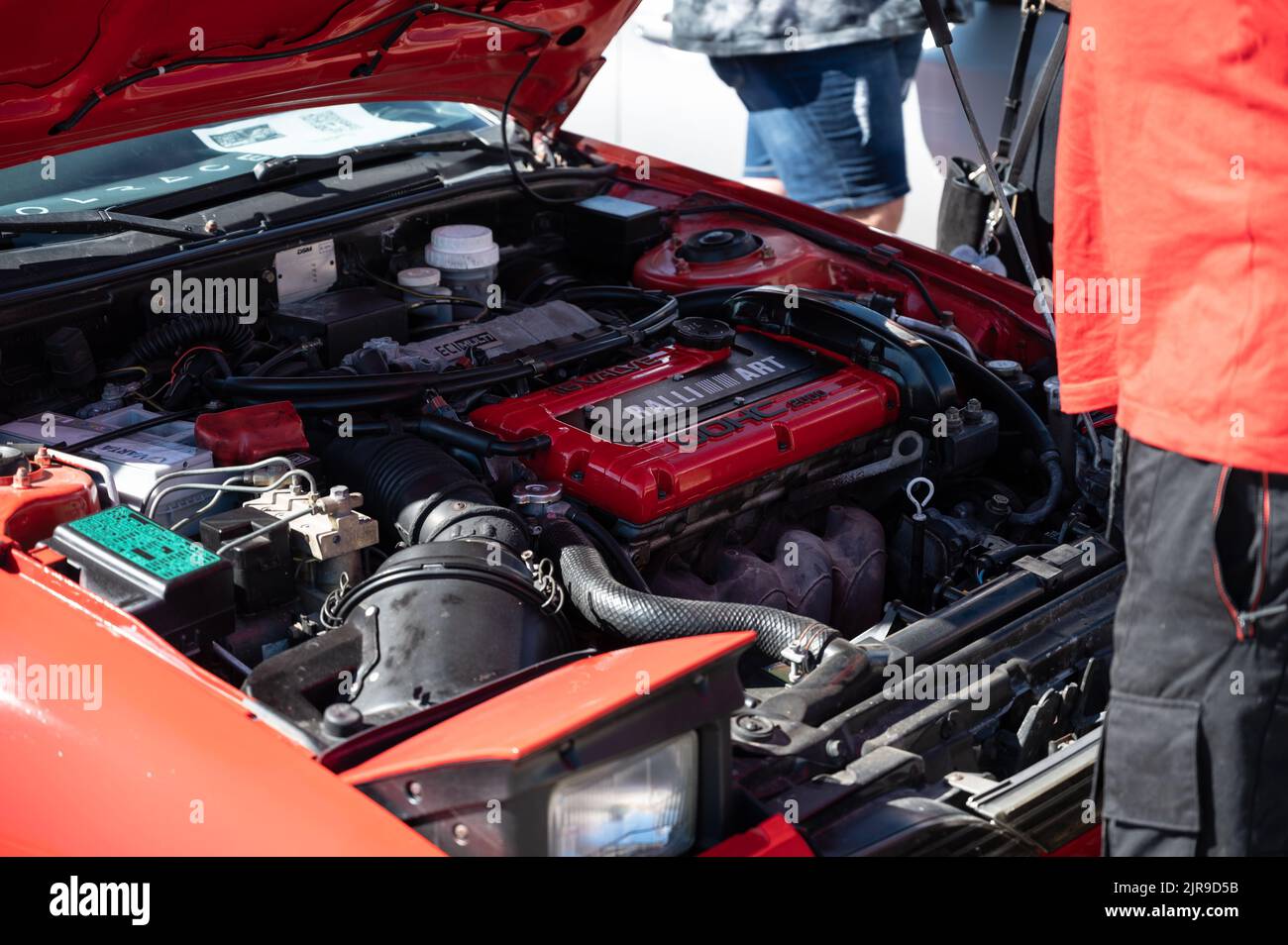 A detail of an engine of a red vintage first-generation Mitsubishi ...