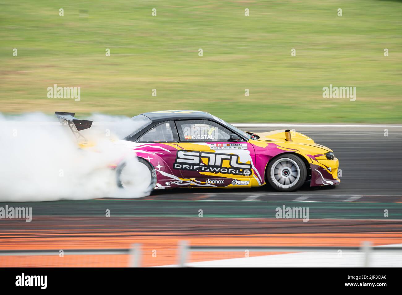 A Japanese yellow Nissan Silvia S14 Kouki car skidding on a circuit ...
