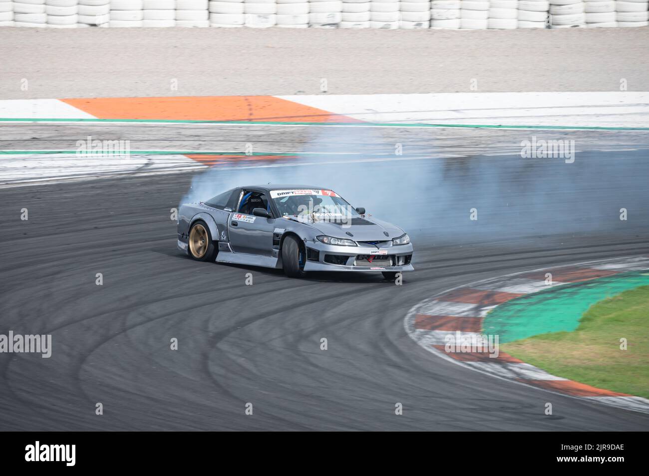 A silver Nissan Silvia S13 5 drifting on a race track Stock Photo - Alamy