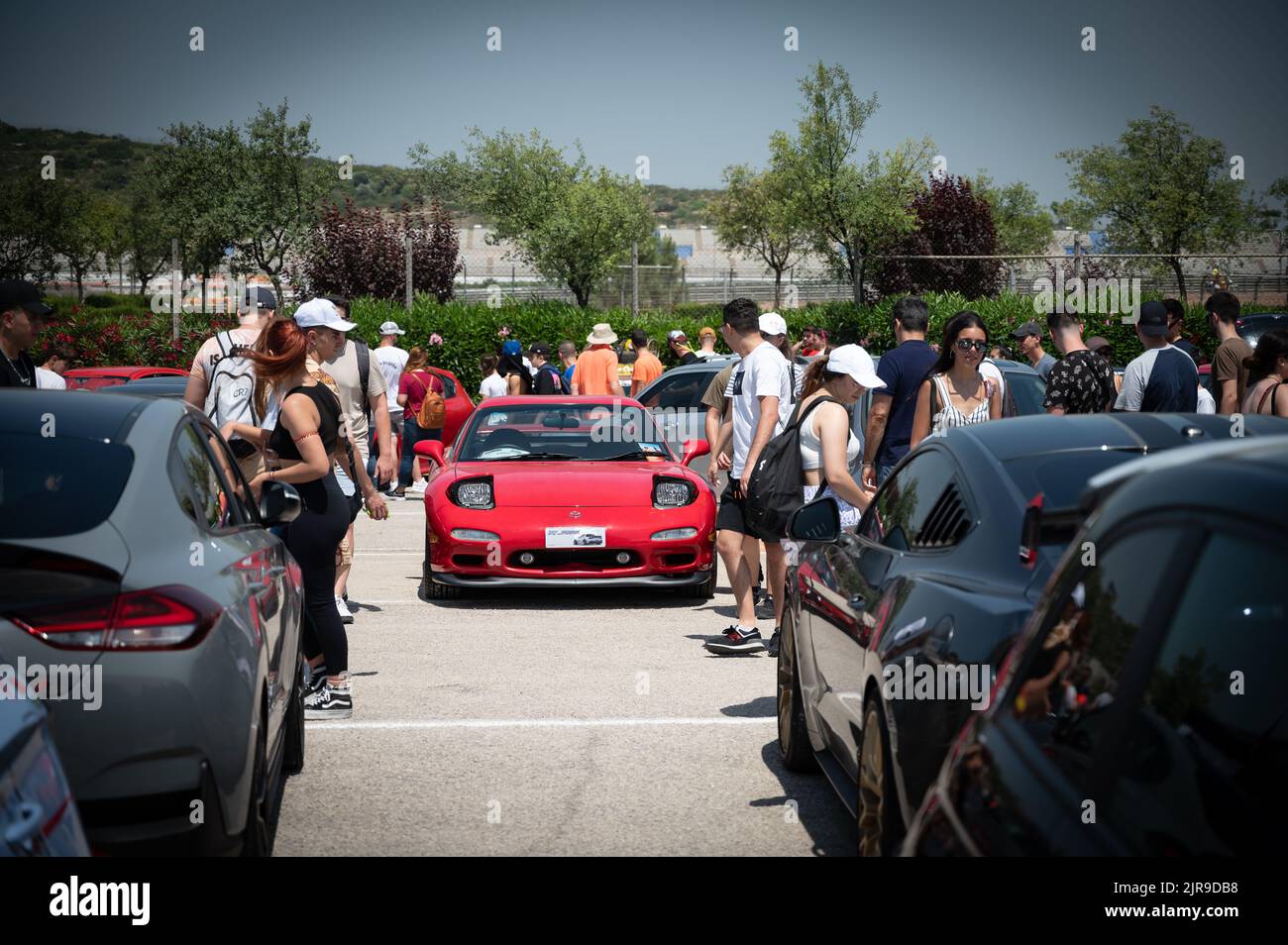 A front view of a classic red Japanese Mazda RX-7 parked on a crowded ...
