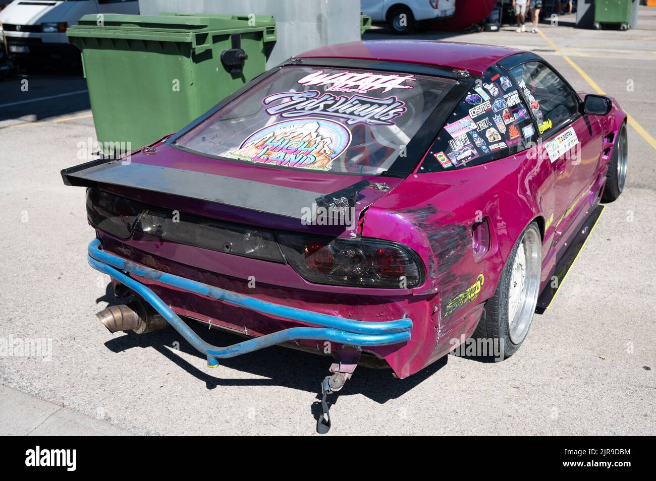 A rear view of the bumps and scratches of a purple Nissan Silvia S13 ...