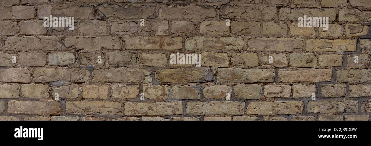 Wide weathered beige brown brick wall background Stock Photo - Alamy