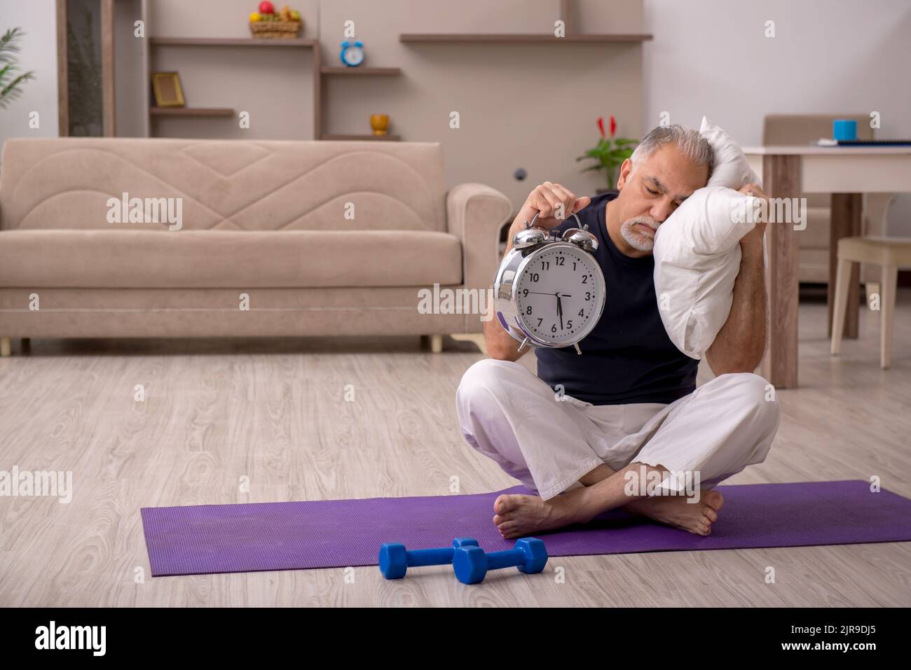 Old man doing sport exercises indoors Stock Photo - Alamy