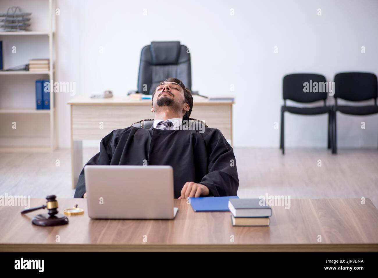 Young judge working in the courthouse Stock Photo - Alamy