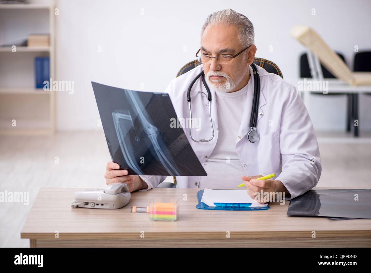 Old male doctor radiologist working at the hospital Stock Photo - Alamy