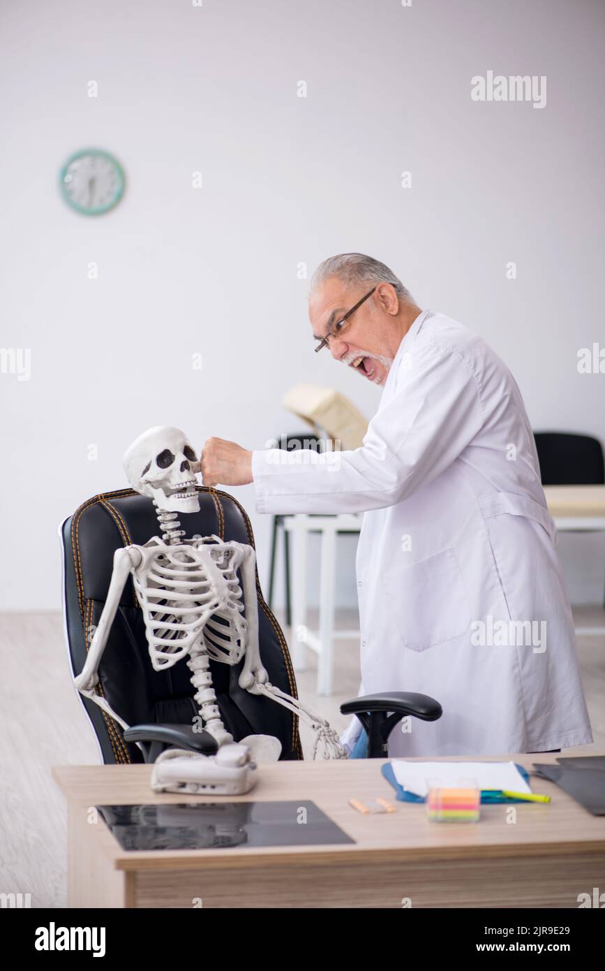 Old doctor with skeleton at the hospital Stock Photo - Alamy