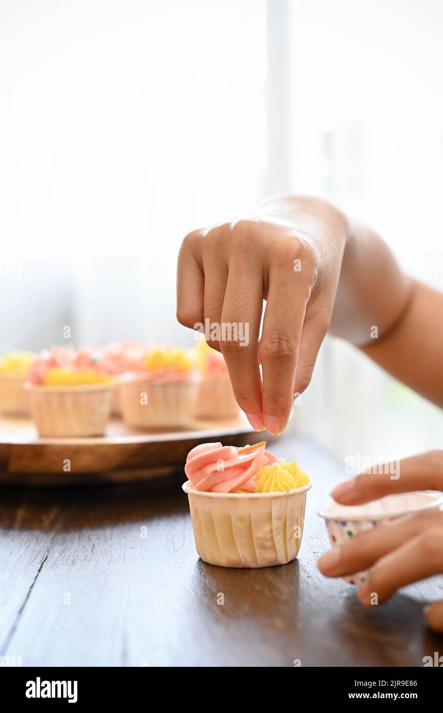 close-up image, A professional female baker making a cupcake in her ...