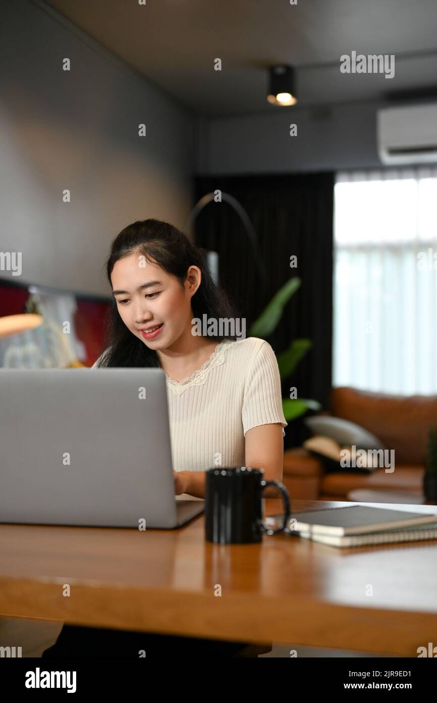 Portrait, Pretty and attractive young Asian female in the living room ...