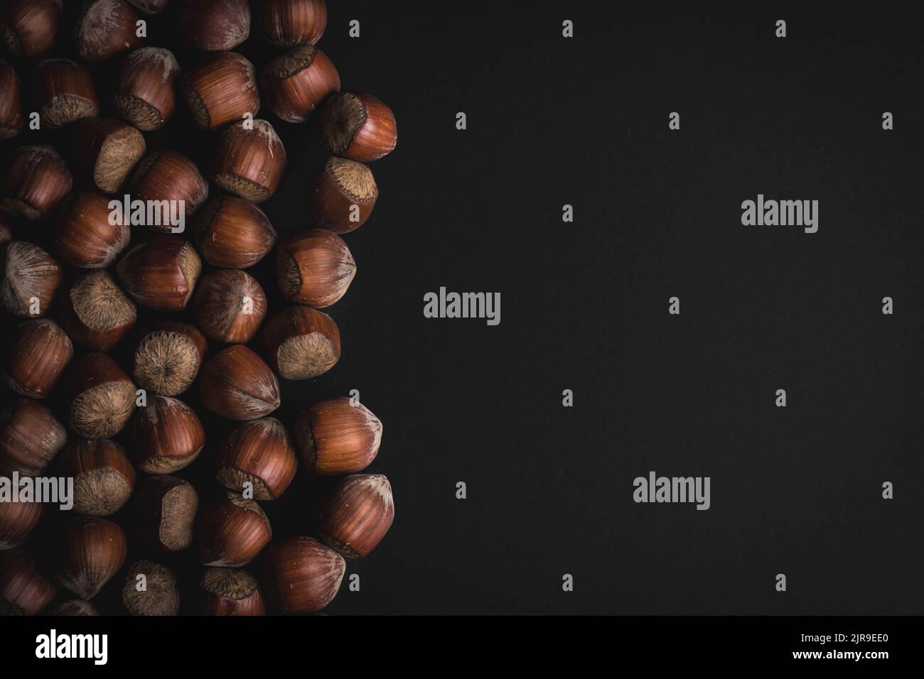 Hazelnuts on black background. Food background, photo wallpaper Stock ...