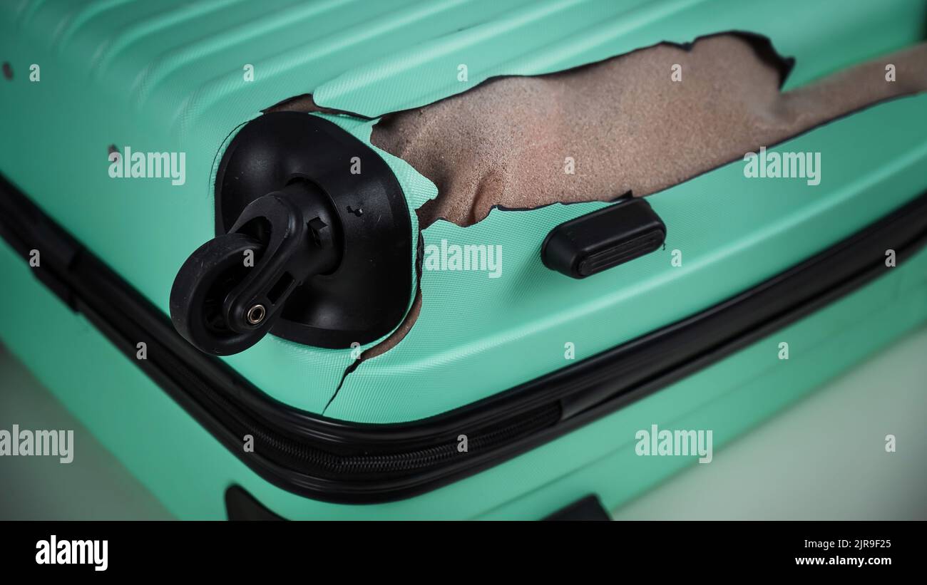 Mint damaged suitcase on a white background Stock Photo - Alamy