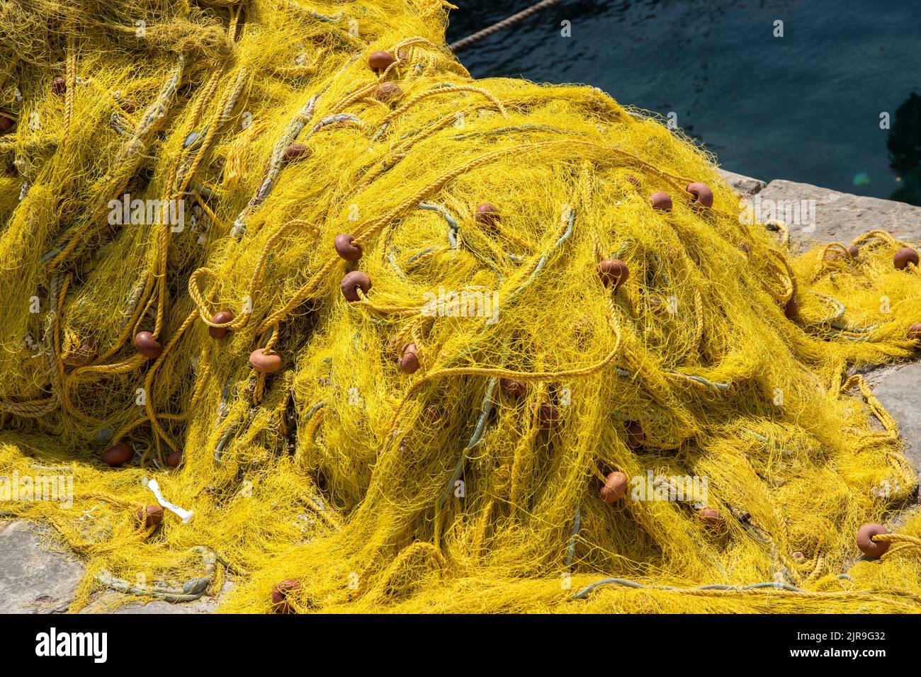 Pile of fishing net closeup on pier Stock Photo - Alamy