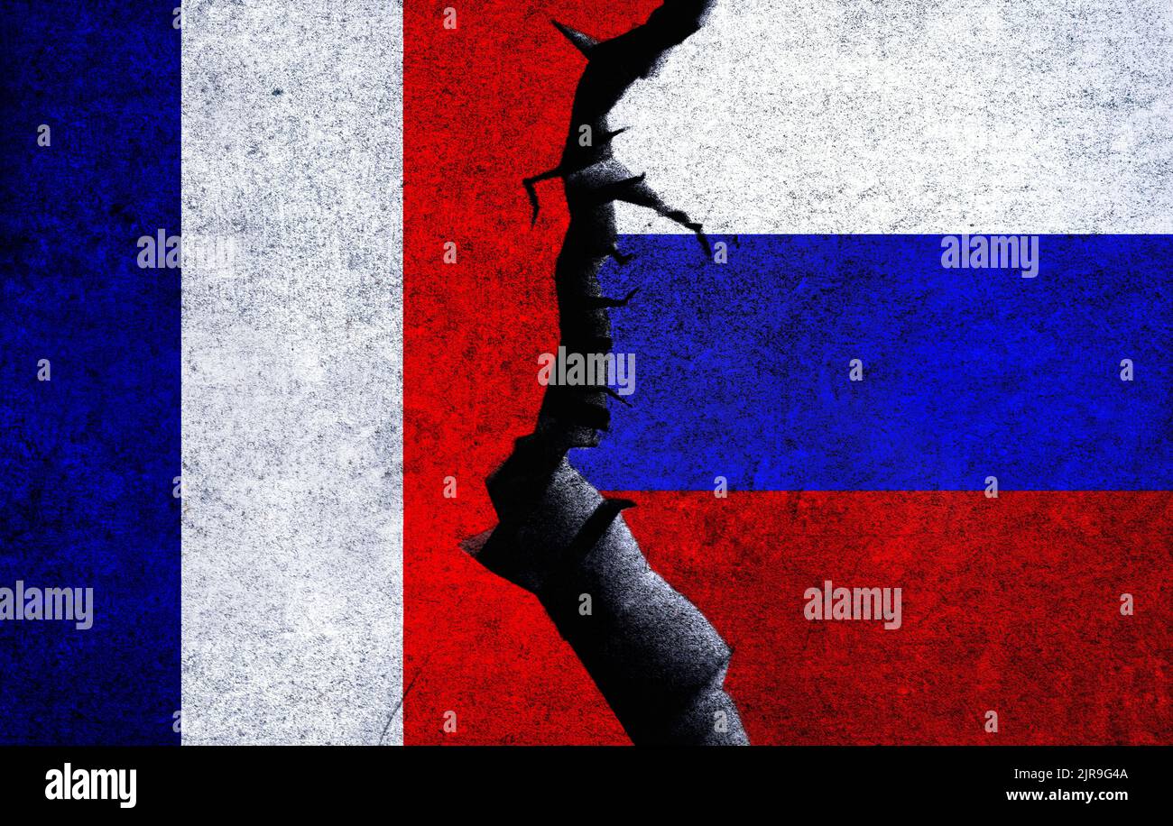 Russia vs France concept flags on a wall with a crack. France and ...