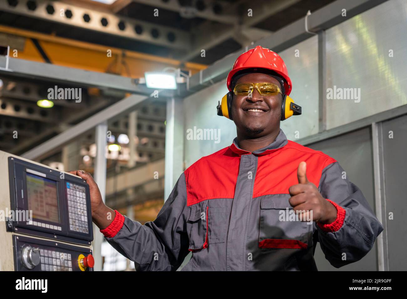 Portrait Of Black Machine Operator In Red Helmet, Safety Goggles ...
