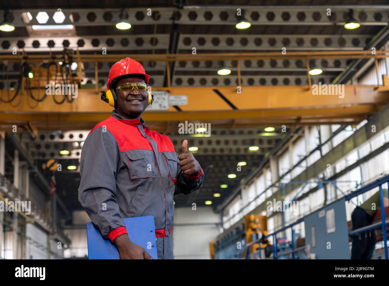 Portrait Of Black Worker In Red Helmet, Safety Goggles, Hearing ...