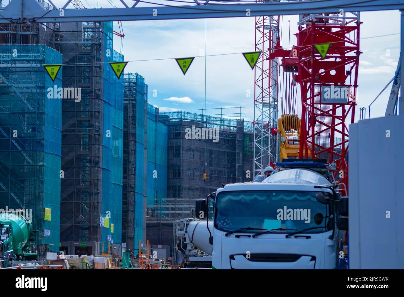 Cranes at the under construction daytime long shot Stock Photo - Alamy