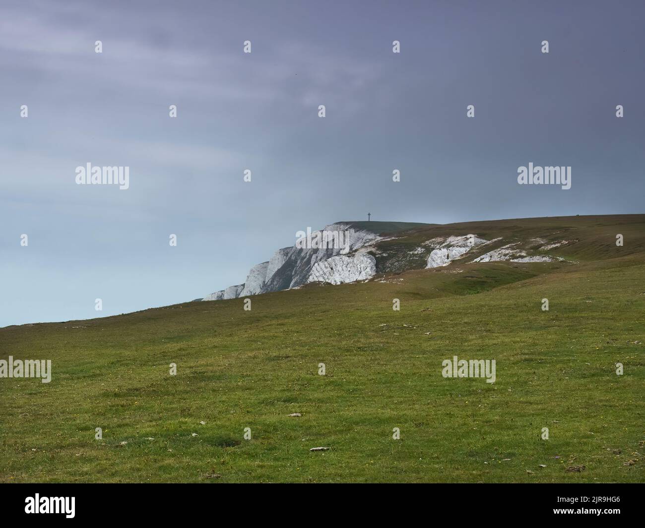 A sweep of cliff top heathland wilderness, topped by a distant monument ...