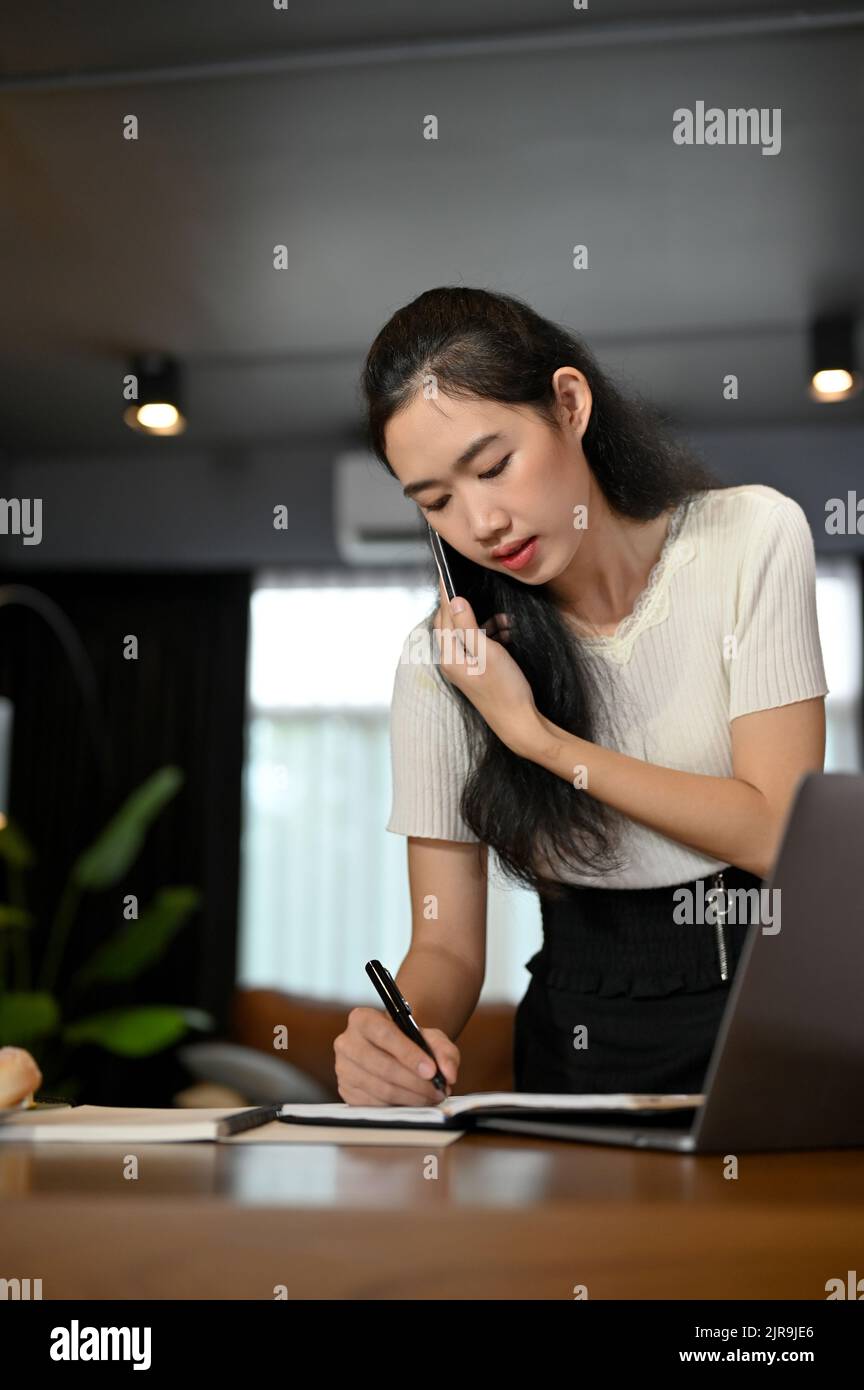 Portrait, Beautiful millennial Asian female secretary taking notes on ...