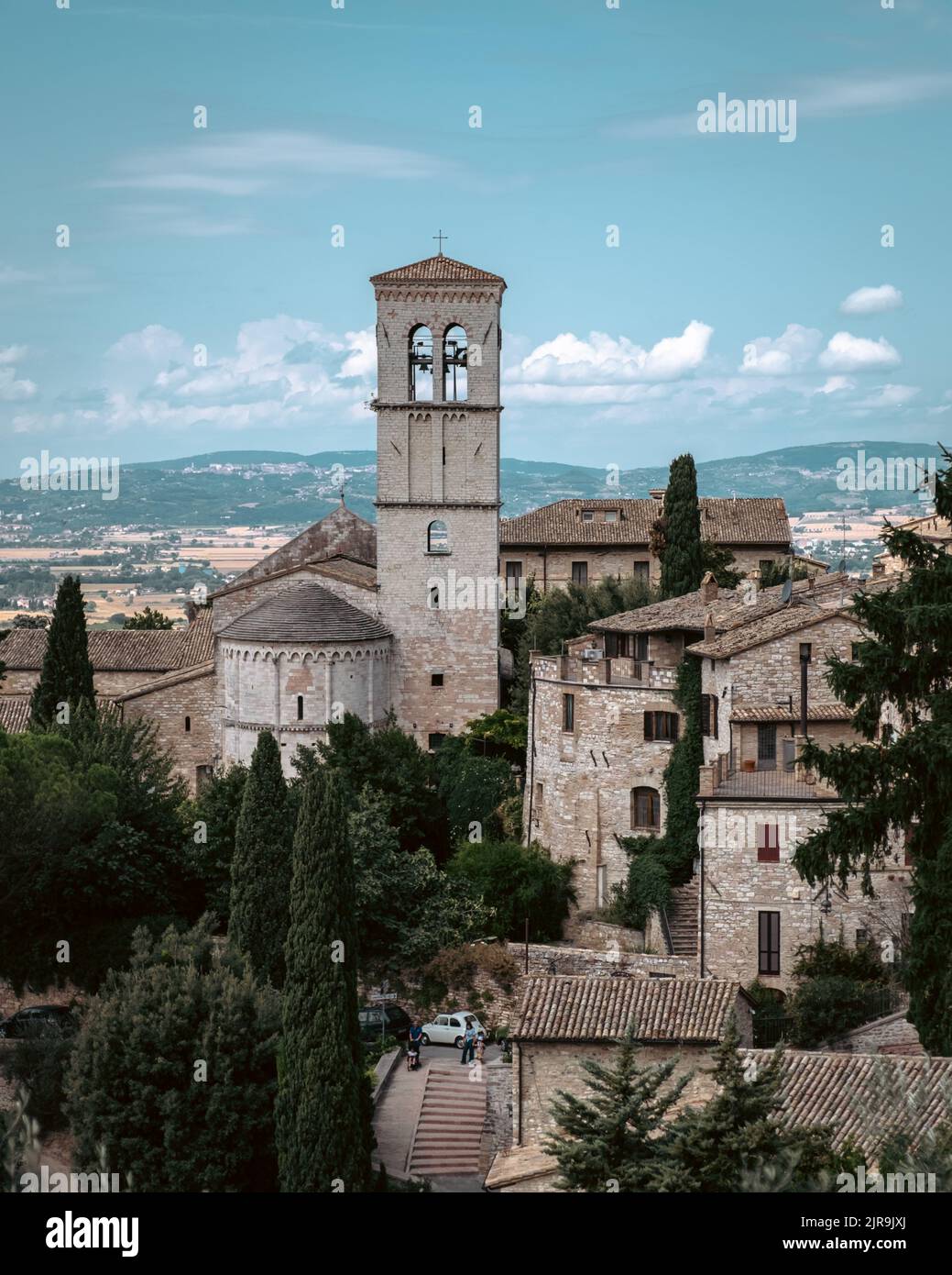 A small town in the italy countryside with a church and a tower bell on ...
