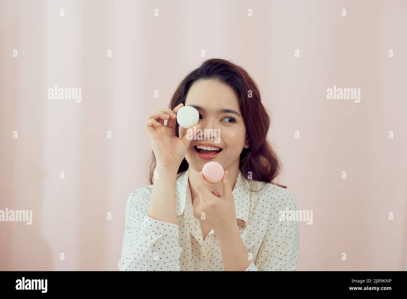 Close up photo of beautiful lady hide eye with little french macaron ...