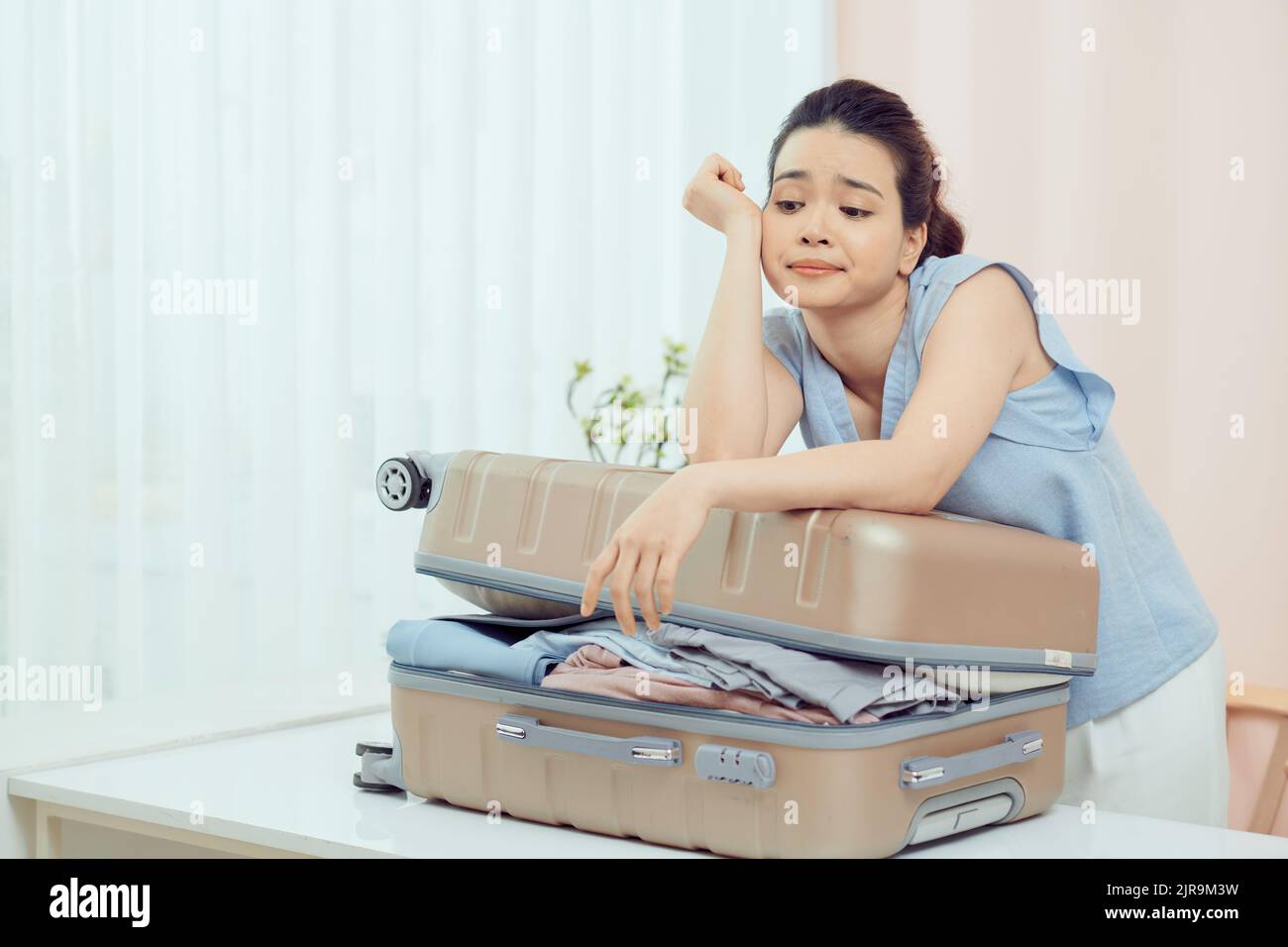 a young woman packing her suitcase for the trip to the holiday Stock ...