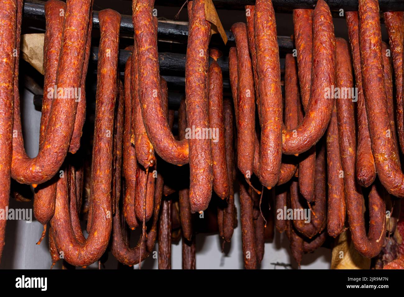 Smoked, dry, cured sausages hanging in the vintage smokehouse Stock ...