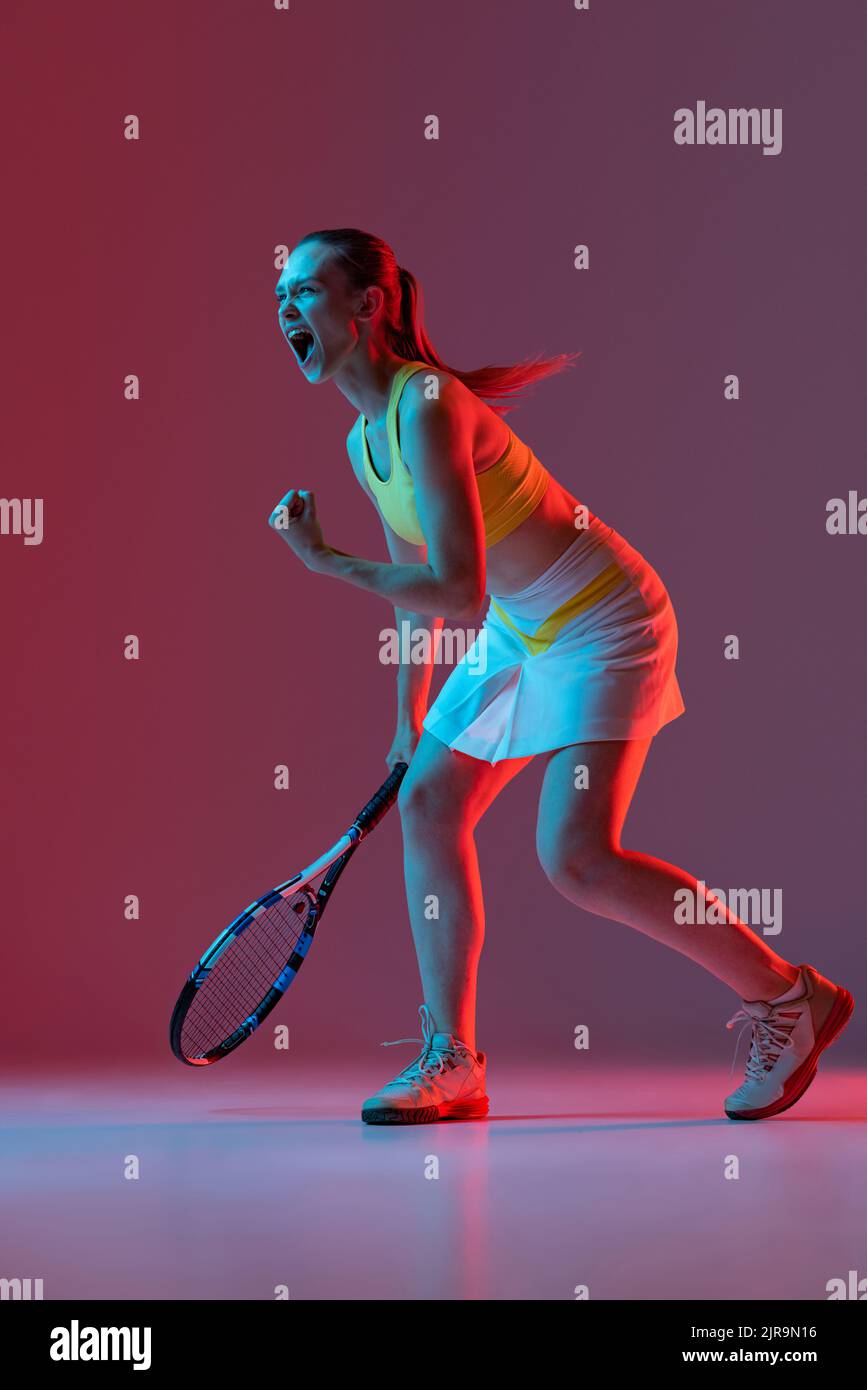 Excited young woman, tennis player shouting after sports win isolated ...